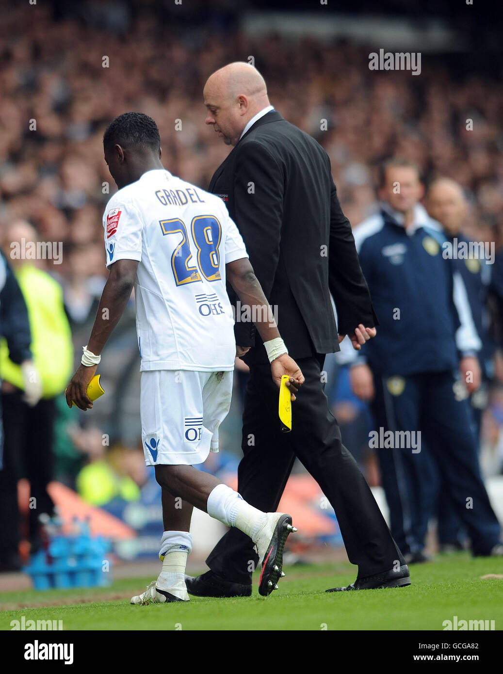 Leeds United's Max Gradel is escorted off the pitch by security after ...