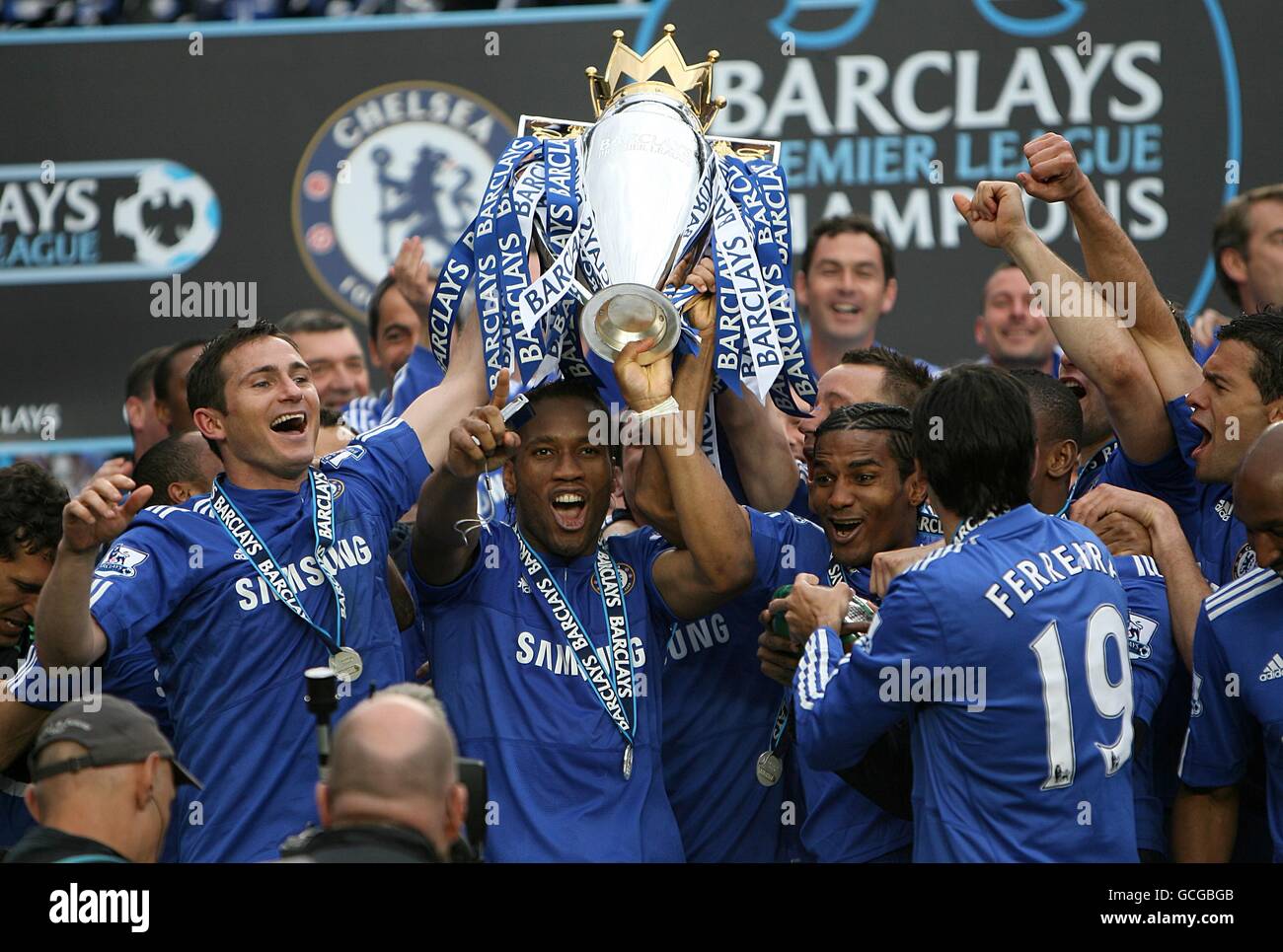 Chelsea players lift the Premier League trophy at Stamford Bridge (left ...