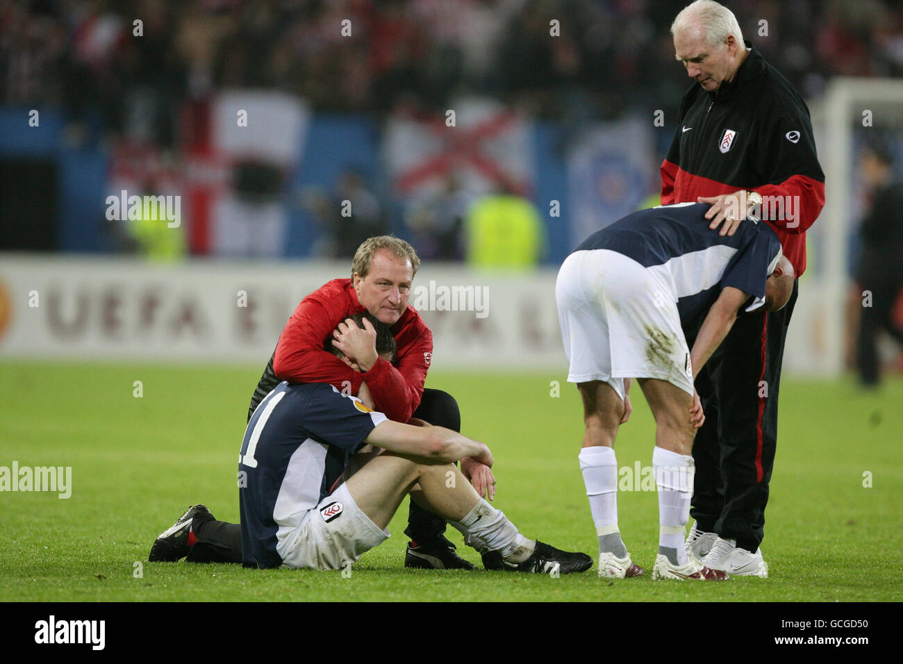 Fulham's Zoltan Gera (left) is consoled by first team coach Ray ...
