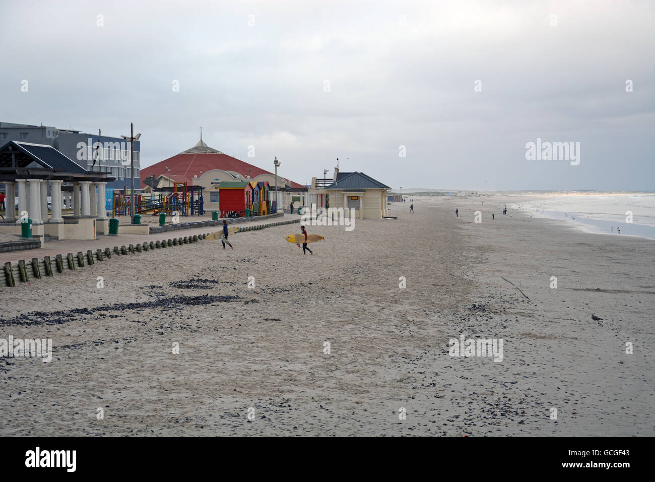 Surfers at a long stretch of Muizenberg Beach on the False Bay, Cape ...