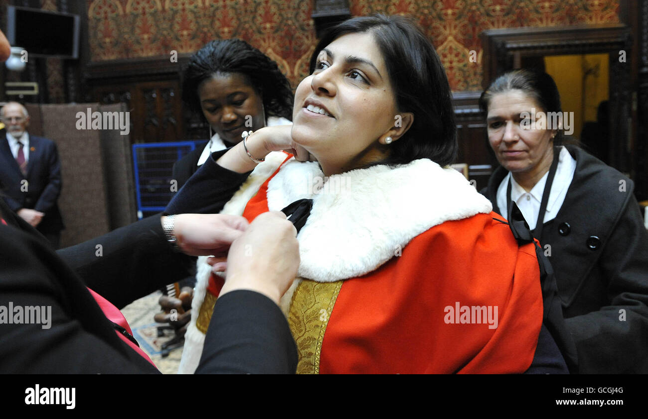 Baroness Warsi putting on robes before the State Opening of Parliament ...