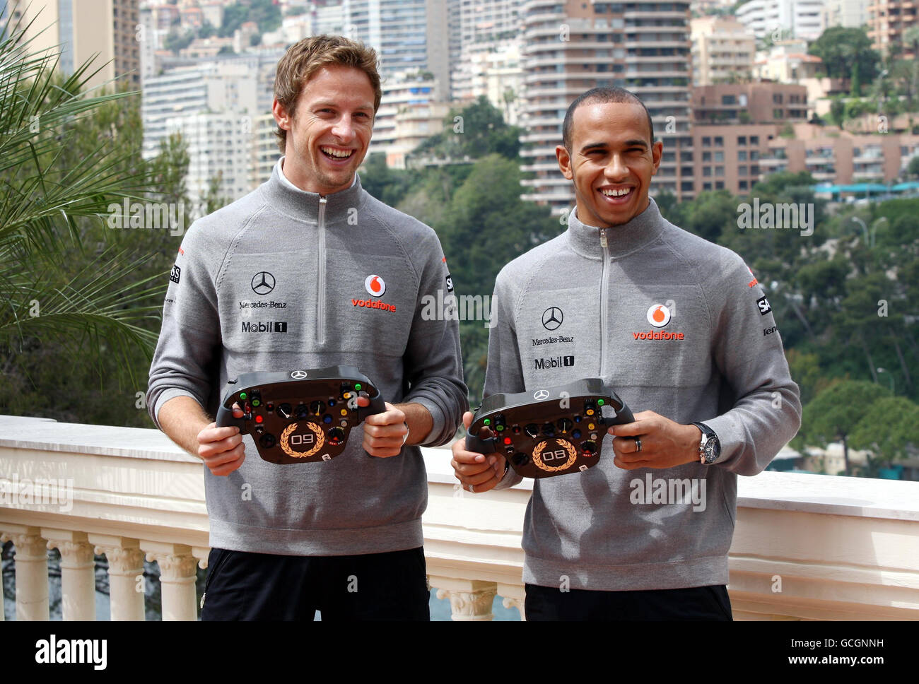 McLaren drivers Jenson Button and Lewis Hamilton pose with their Monaco ...