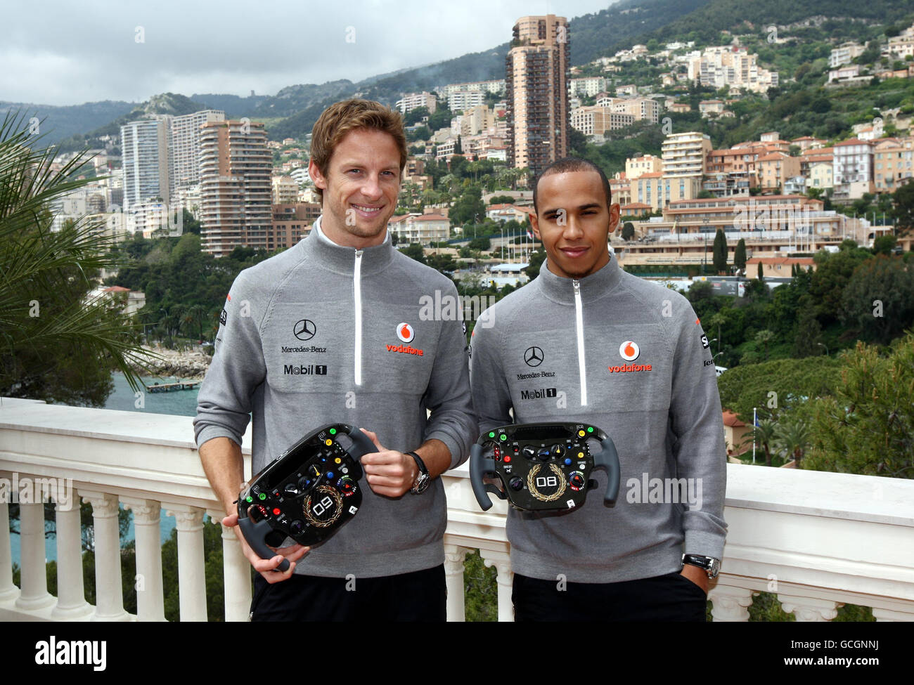 McLaren drivers Jenson Button and Lewis Hamilton pose with their Monaco ...
