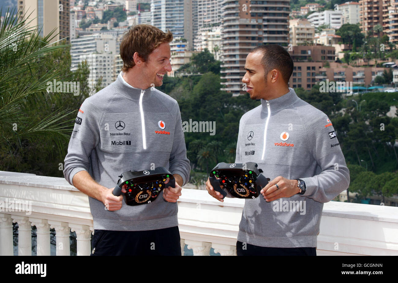McLaren drivers Jenson Button and Lewis Hamilton pose with their Monaco ...