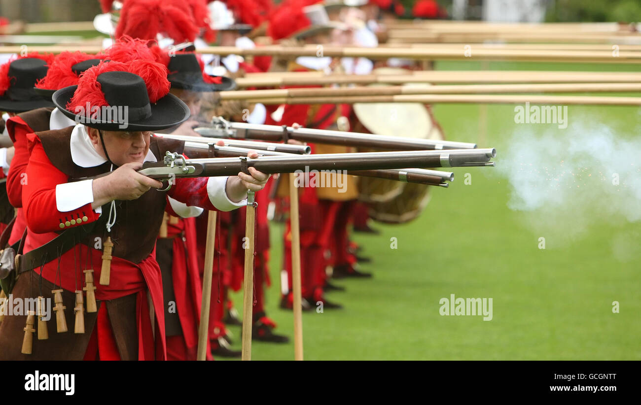 Musketeers fire a volley of shots as Queen Elizabeth II reviews the ...