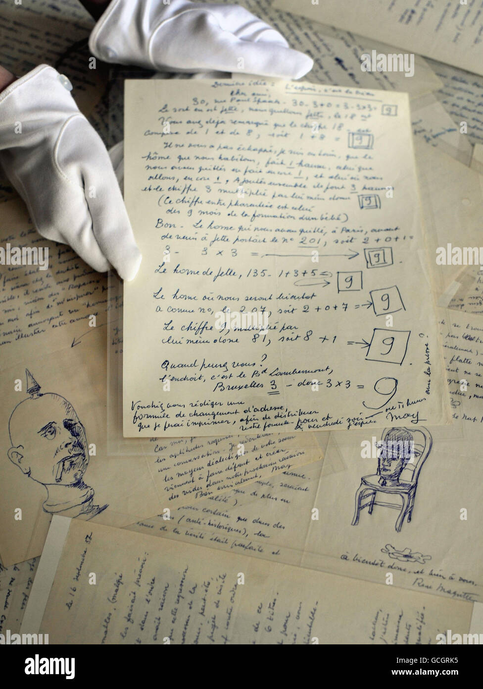 A member of staff holds a letter written by Magritte on the ...