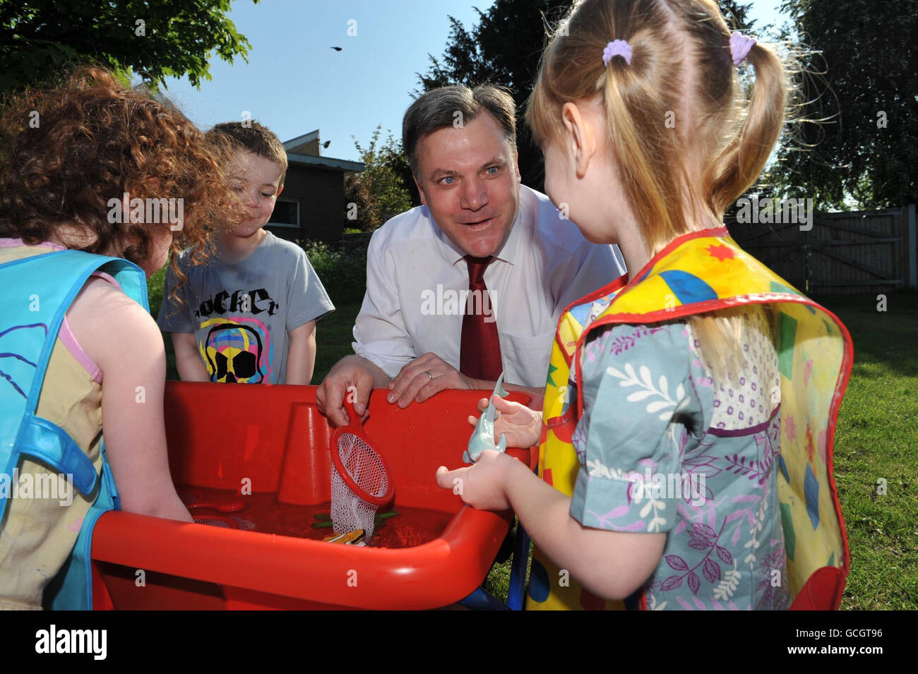 Former children's secretary Ed Balls, plays with some children during a ...