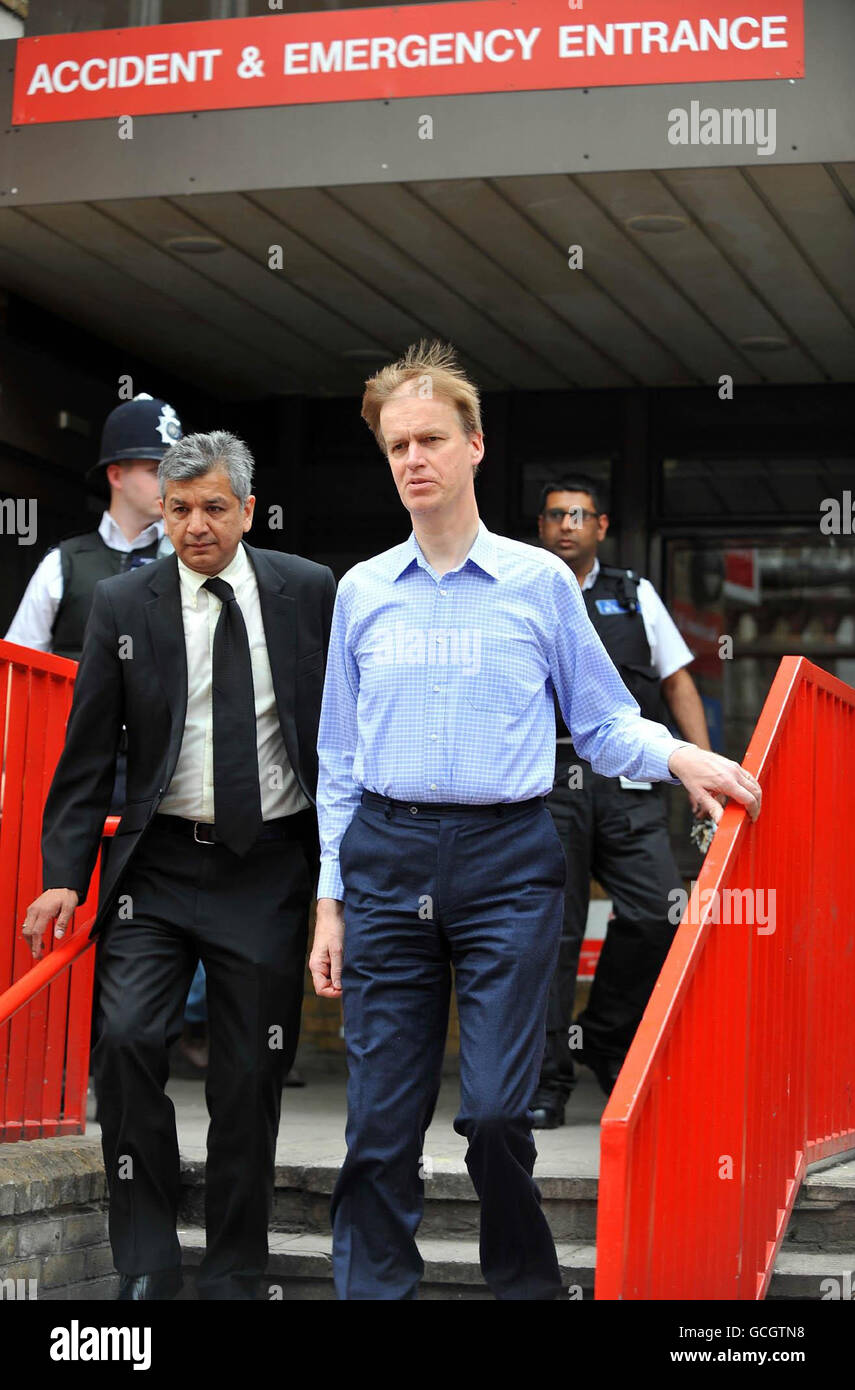 Labour MP Stephen Timms (right) leaves the Royal London Hospital after ...
