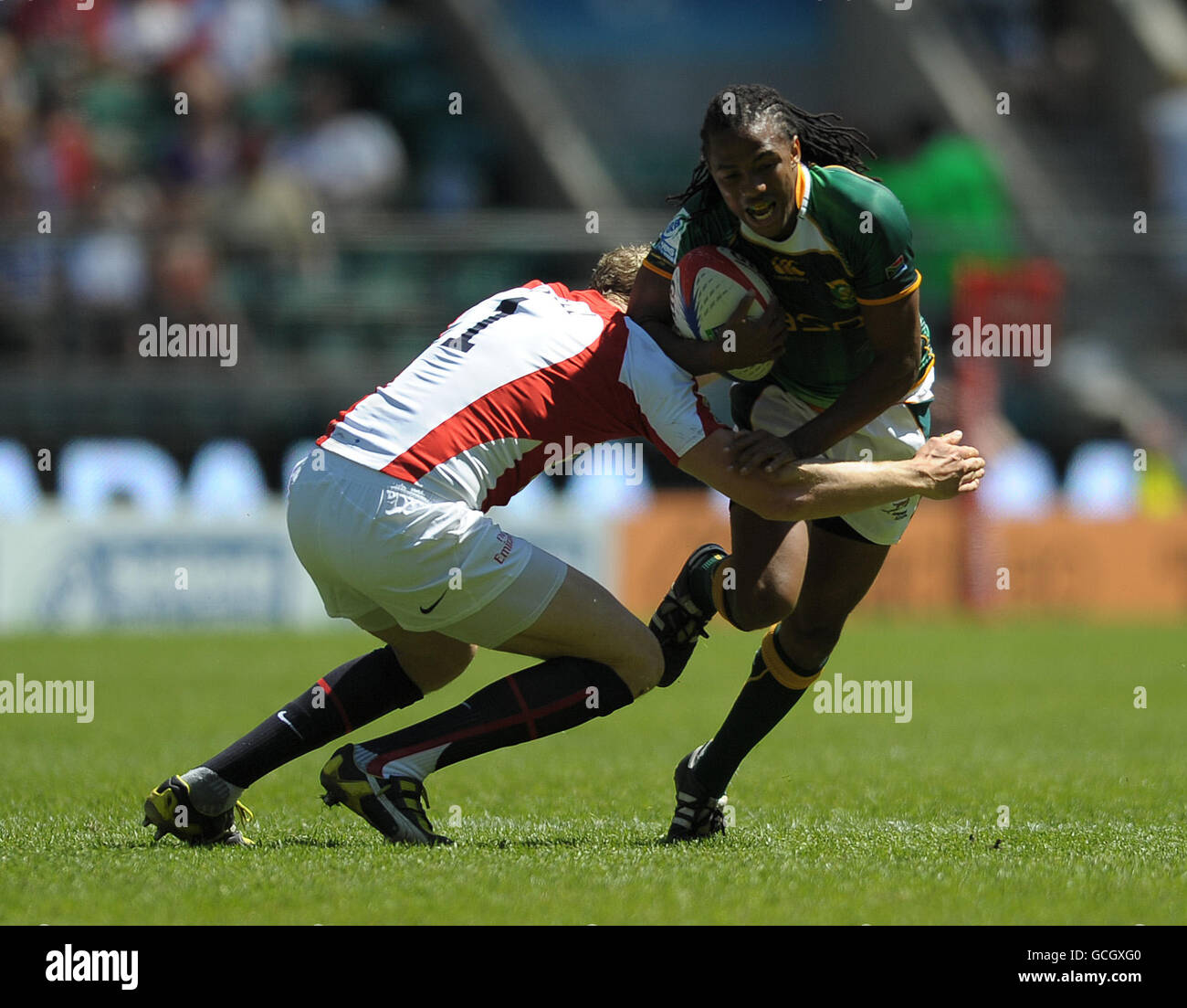 South Africa's Cecil Afrika (right) is tackled by England's Tom Powell ...