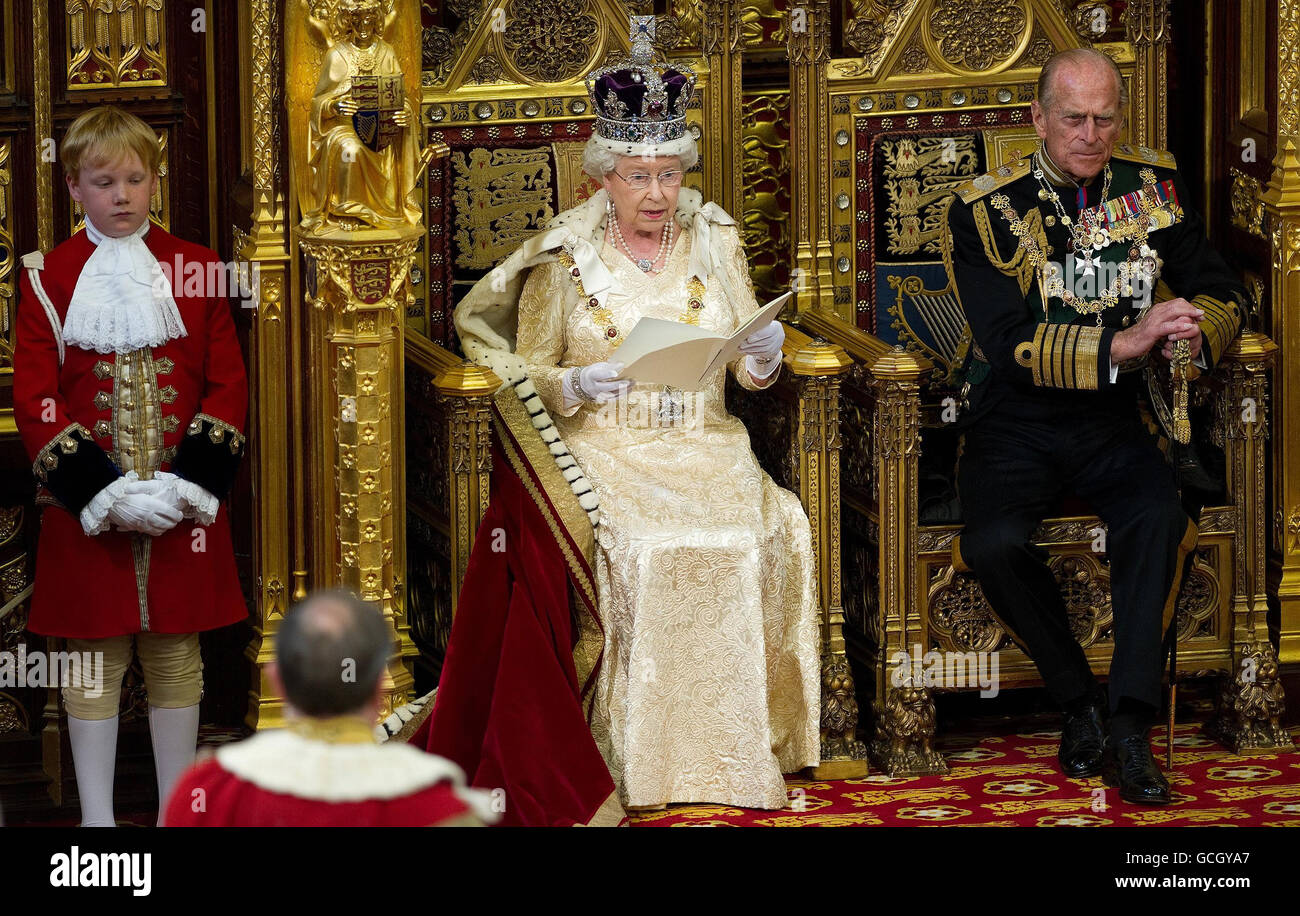The Duke of Edinburgh (right), listens as his wife, Queen Elizabeth II ...