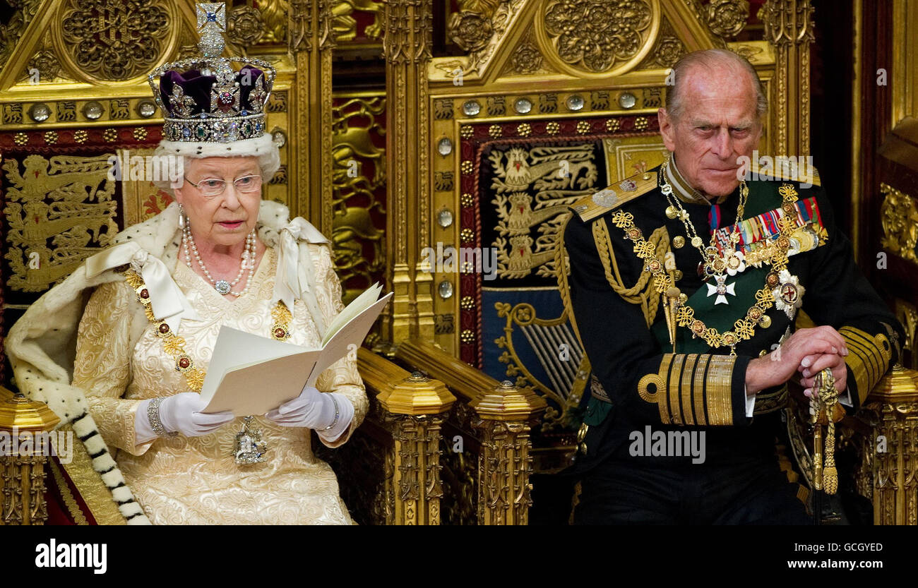 The Duke of Edinburgh (right), listens as his wife, Queen Elizabeth II ...