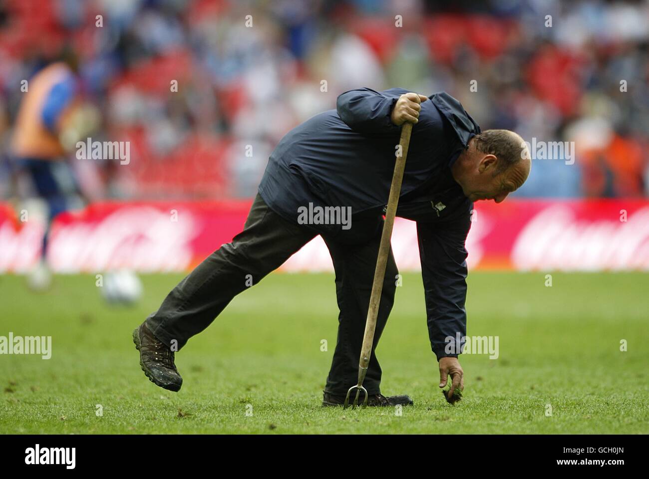A groundsman works on the Wembley pitch during half time Stock Photo ...