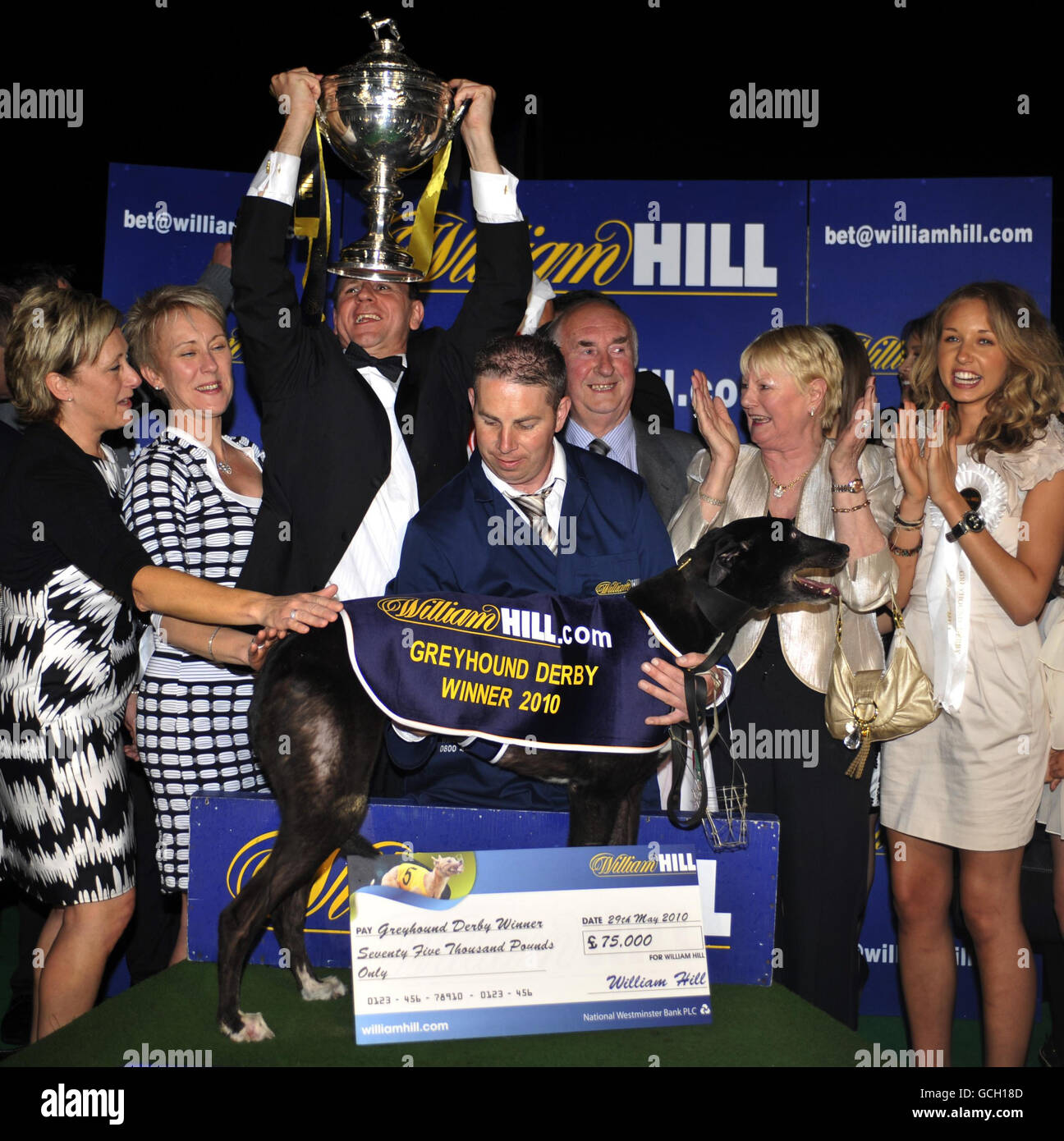 Owner Ray White lifts his third trophy after winning the Williamhill ...
