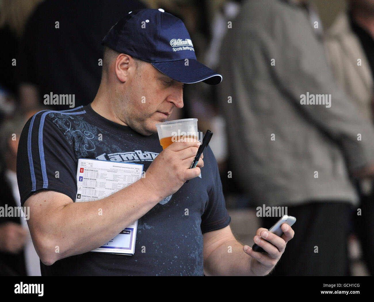 A spectator in the stands during the Wimbledon Greyhound Derby at ...