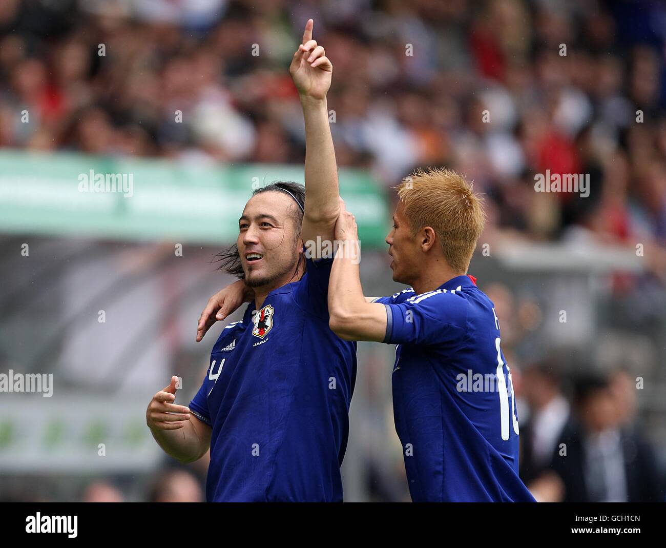 Japan's Marcus Tanaka (left) celebrates scoring his sides first goal of ...
