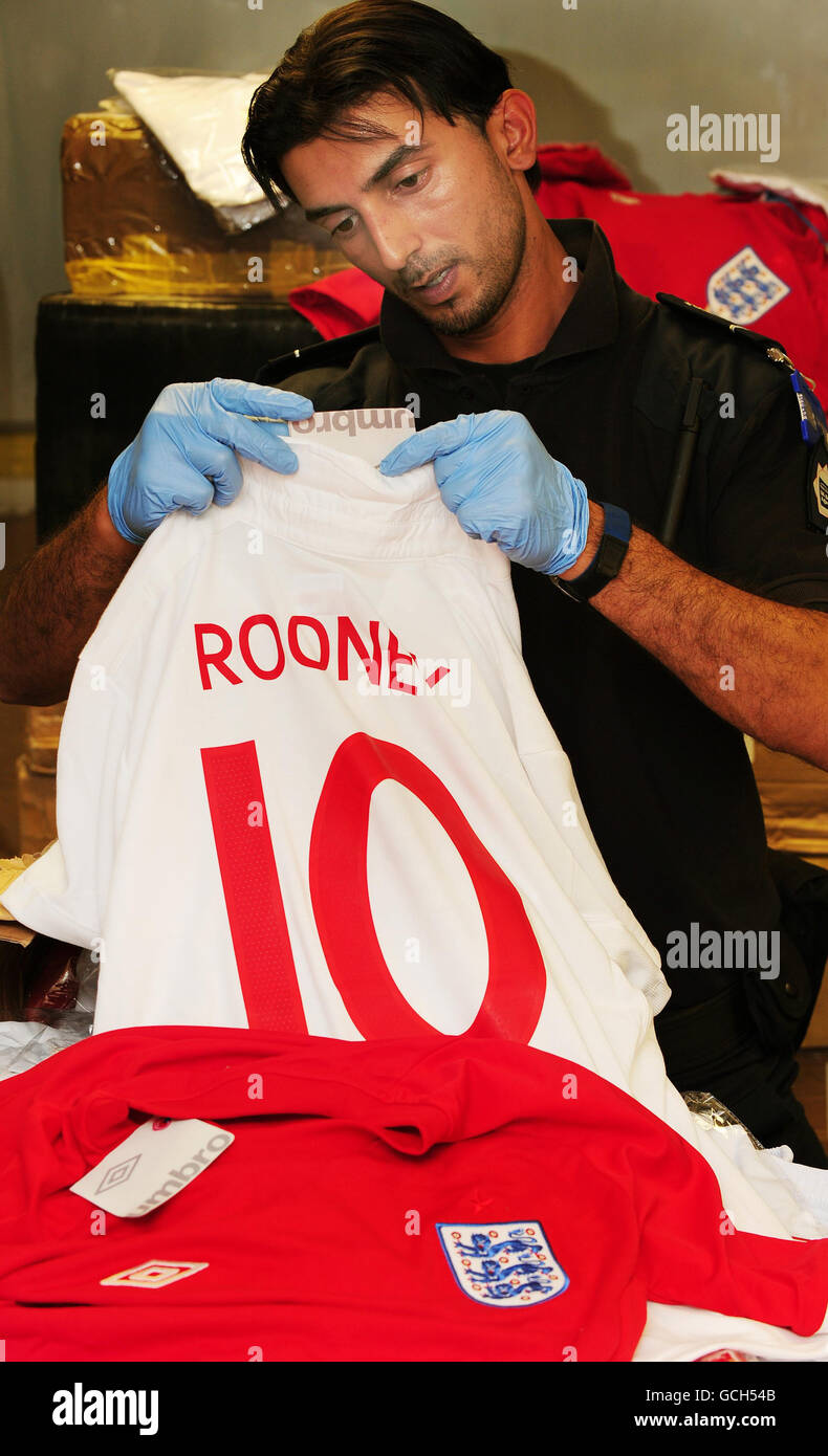 UK Border Agency officer Huroon Malik inspects fake England football ...