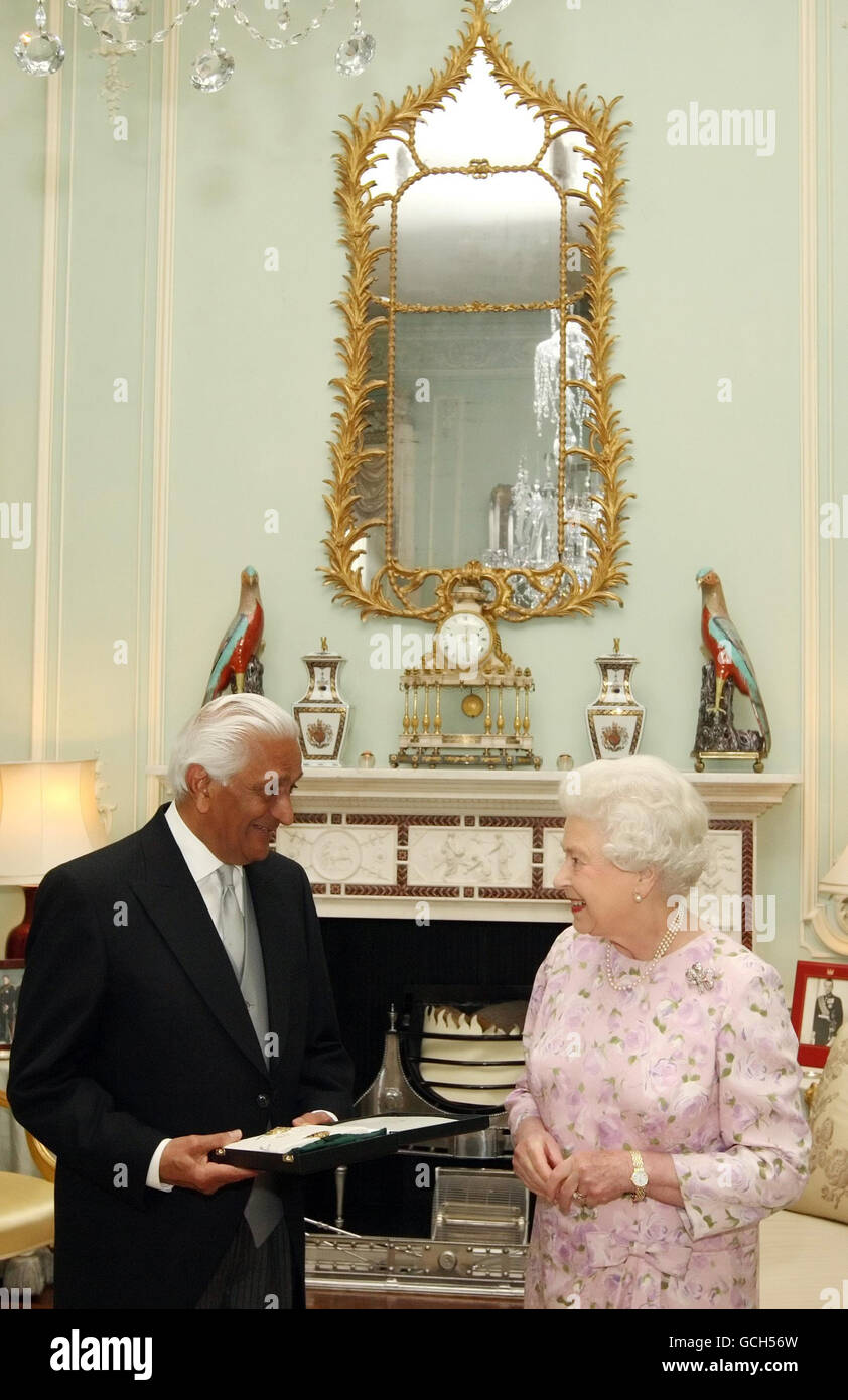 Queen Elizabeth II presents Lord Patel with the insignia of a Knight of ...