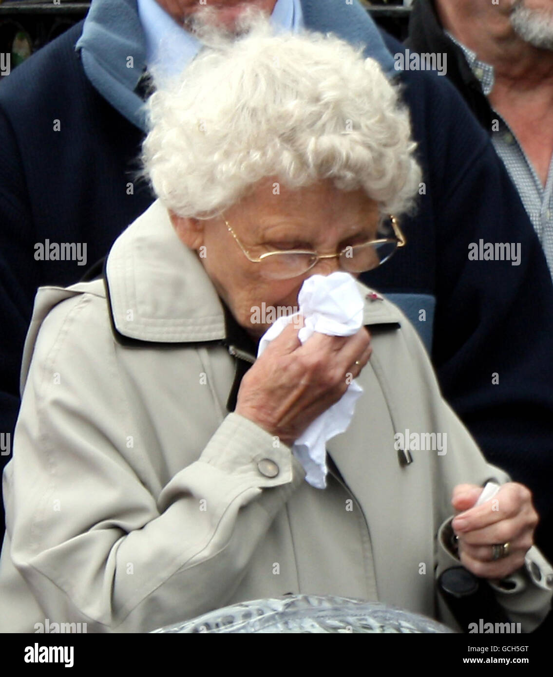 A woman joins residents and friends at the war memorial in Market ...