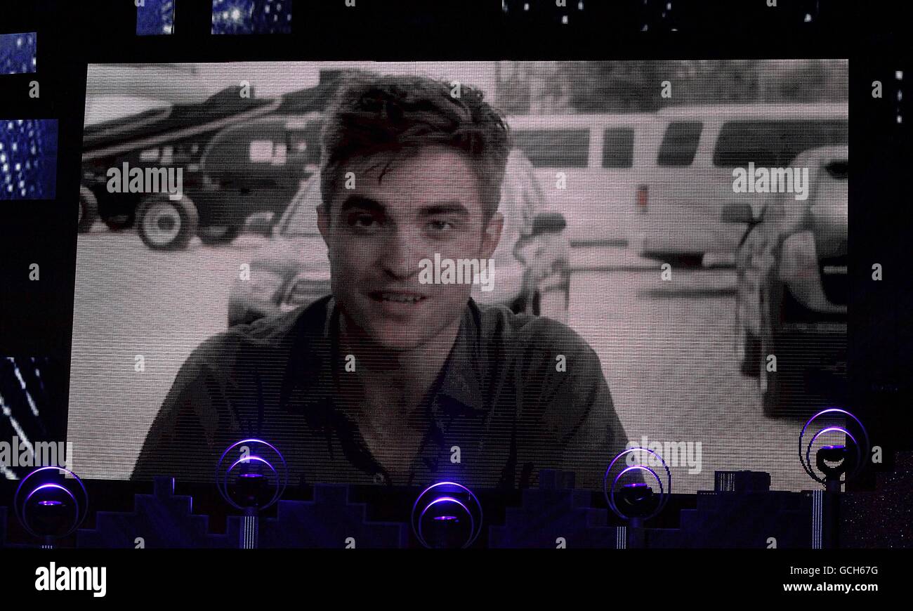 Robert Pattinson on a giant screen to accept the Best Performance award ...