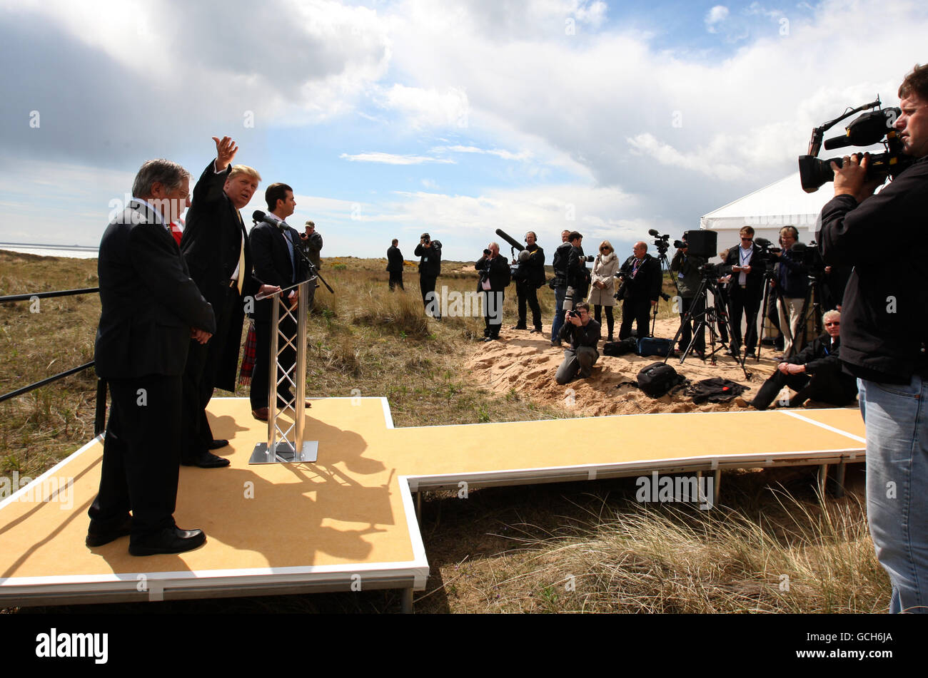 Donald Trump (left, centre) talks to the media on the Menie Estate ...