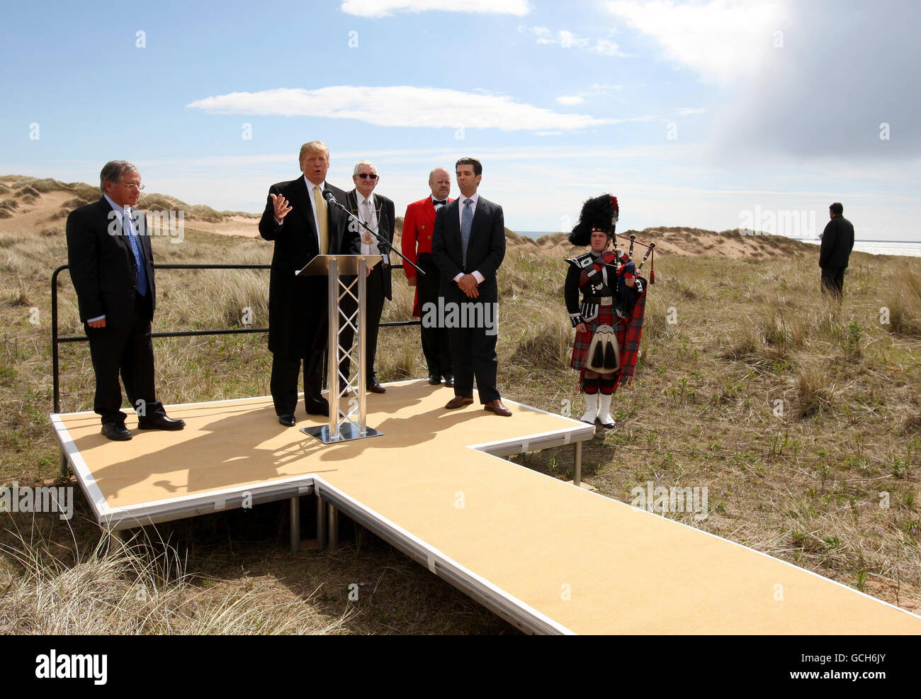 Donald Trump (second left) talks to the media on the Menie Estate ...