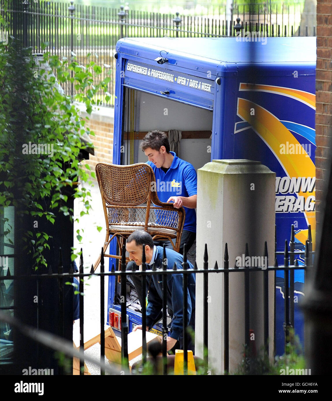 Furniture is taken from a removal van as Prime Minister David Cameron ...