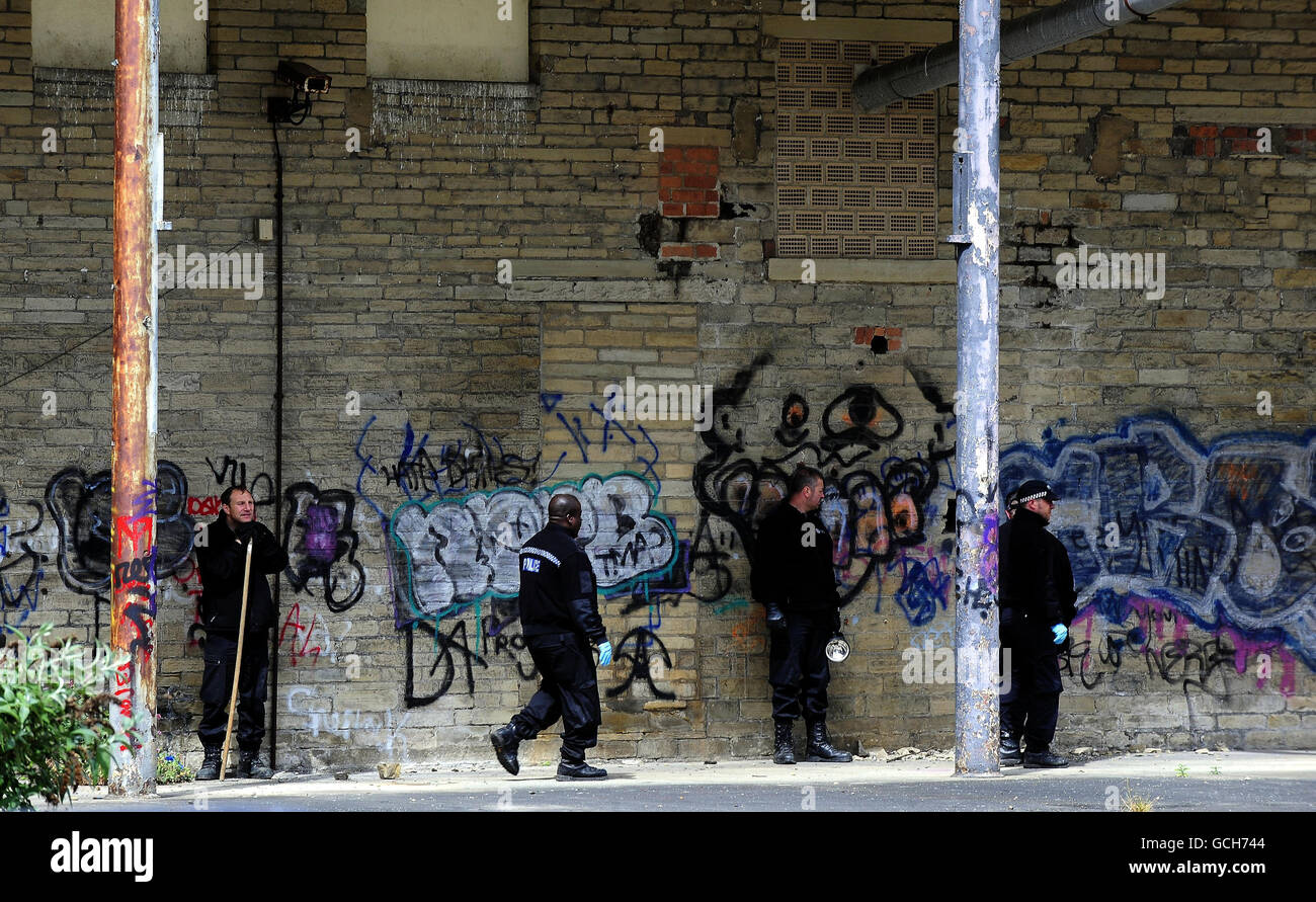 Police officers search the streets around the property of a man ...