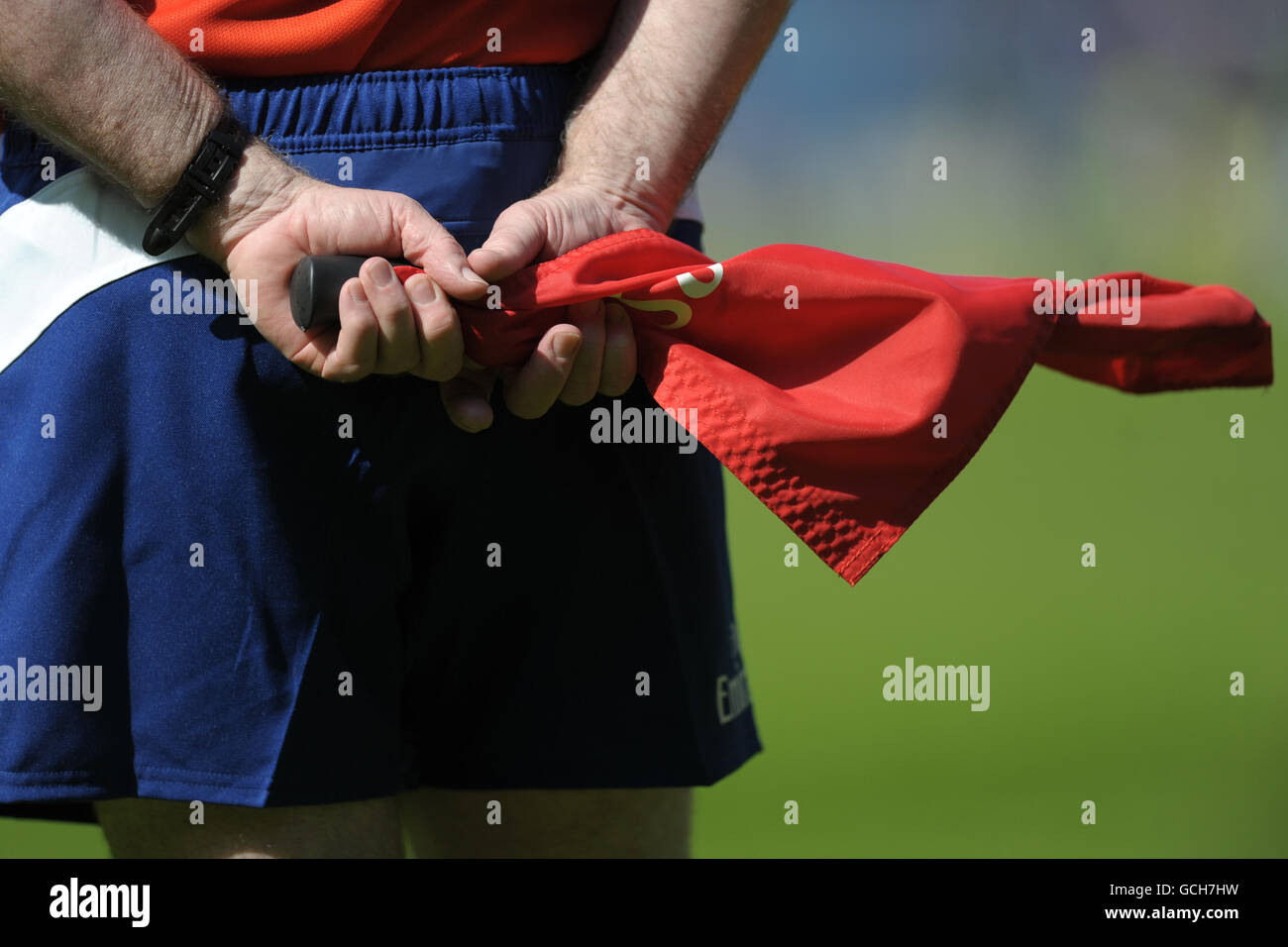 General view of a touch judge holding his flag behind his back during a ...