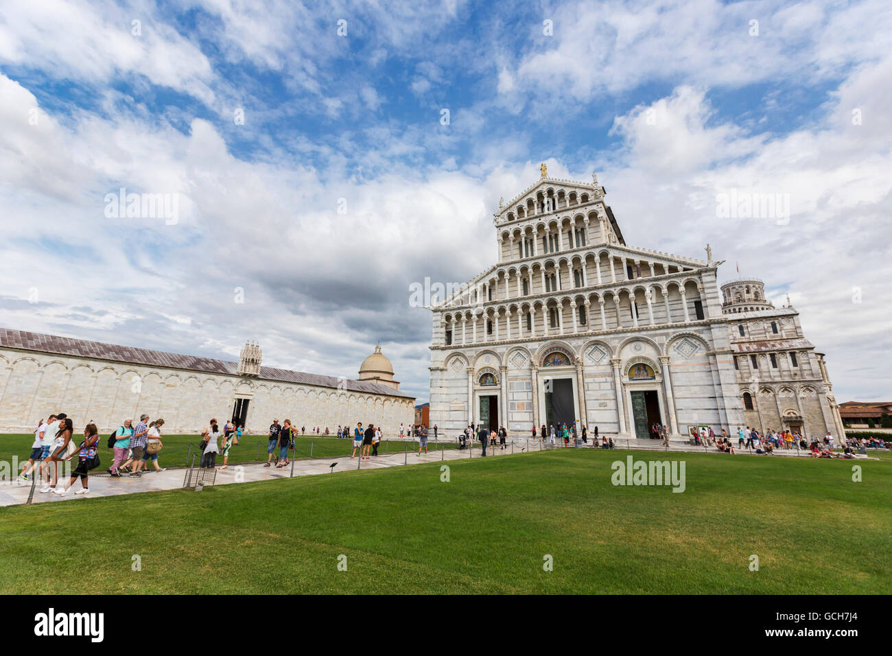 Tourists walk the grounds of the Piazza Dei Miracoli visiting the ...