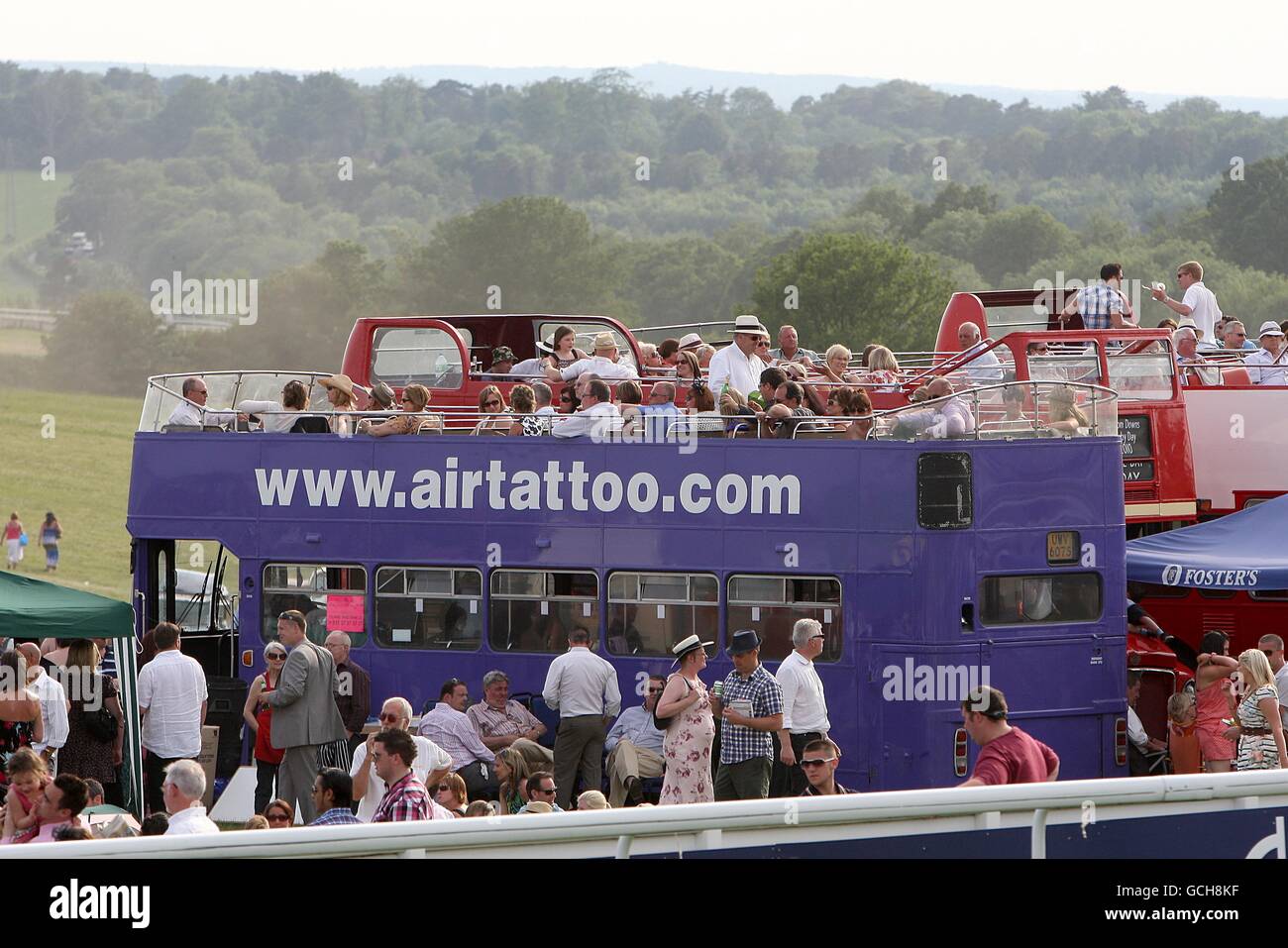 Racegoers enjoying Derby Day on double decker open top buses at Epsom ...