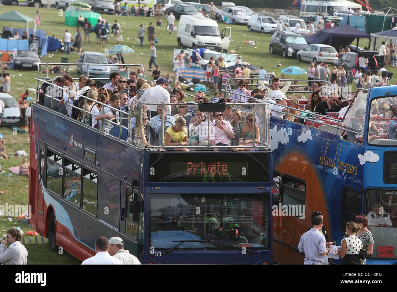 Racegoers enjoying Derby Day on double decker open top buses at Epsom ...