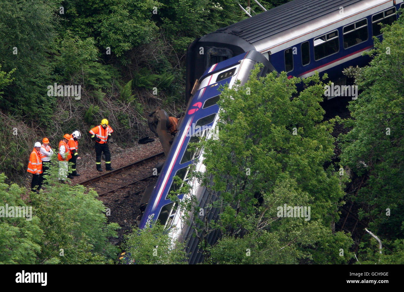 Engineers inspect the derailed train near the Falls of Cruachan power ...