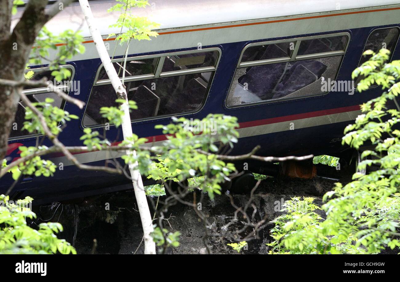 The derailed train seen through trees near the Falls of Cruachan power ...