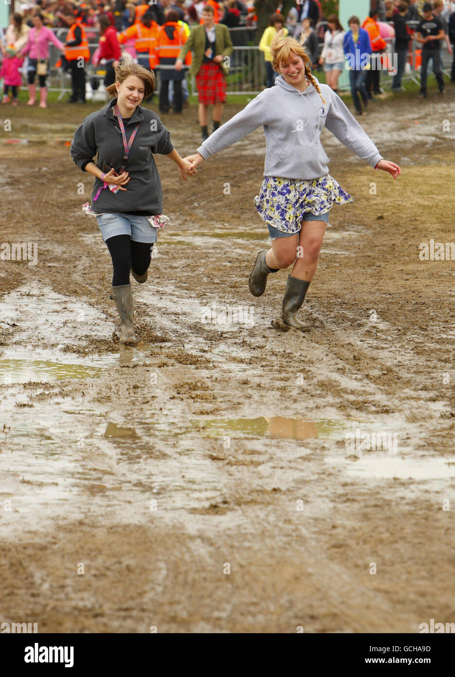 Music lovers walk through muddy puddles as they arrive at Seaclose Park ...