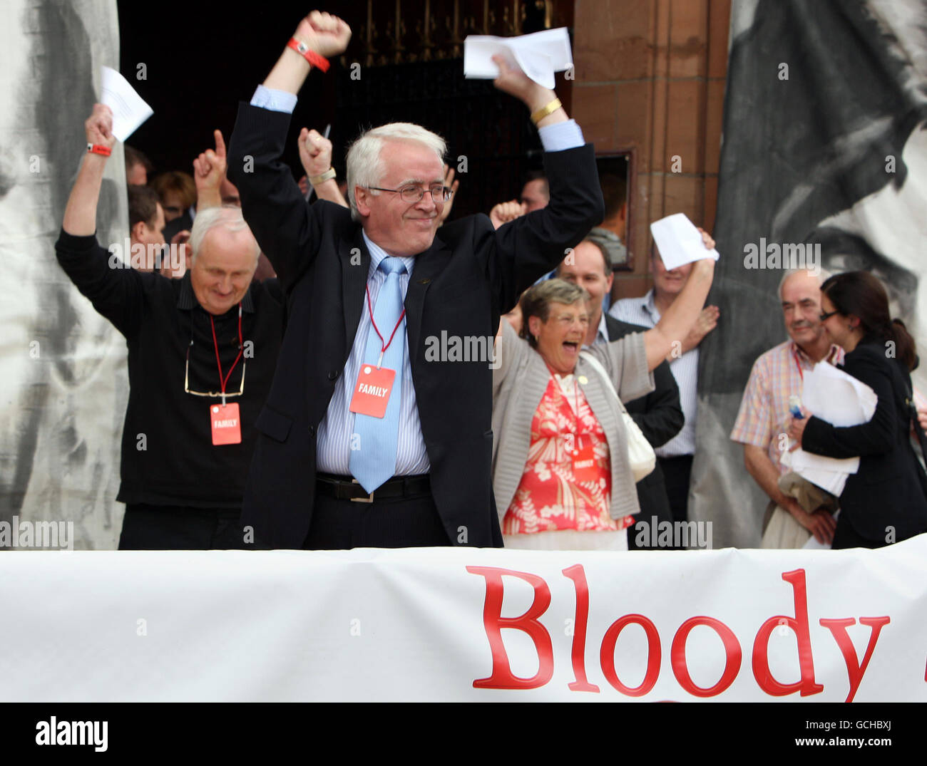 John Kelly (centre), brother of Michael Kelly, celebrates after reading ...