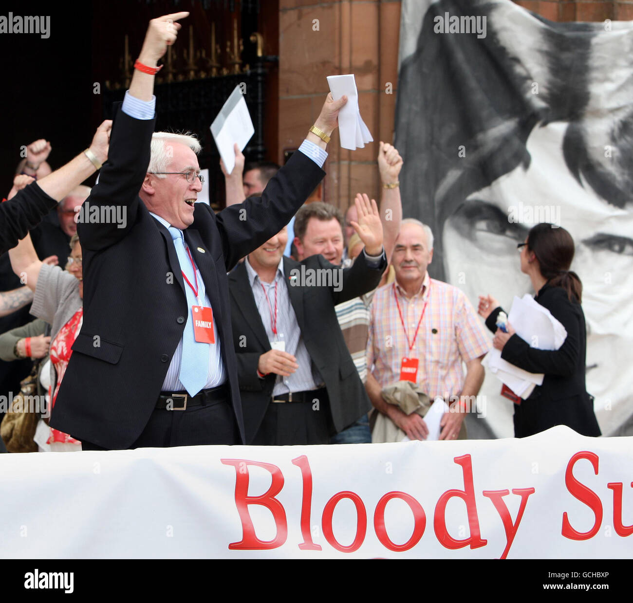 John Kelly (left), brother of Michael Kelly, celebrates after reading a ...