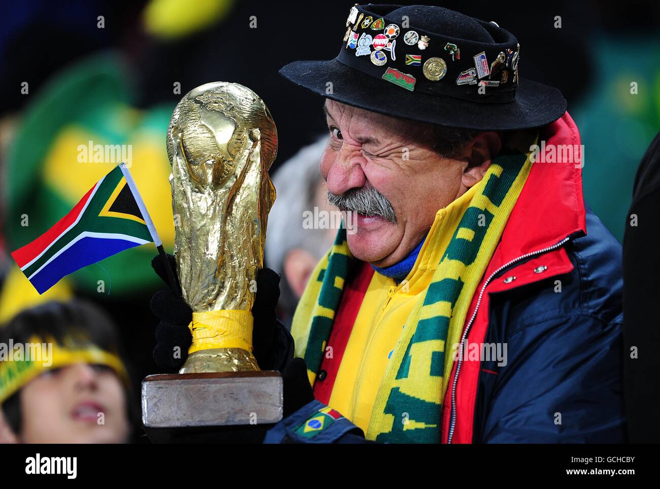 A Brazil fan with a model of the world cup trophy in the stands Stock ...