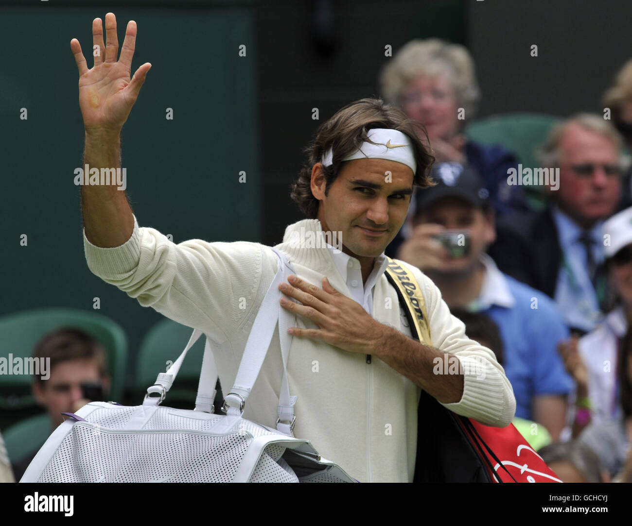 Switzerland's Roger Federer waves to the crowd as he walks on to Centre ...