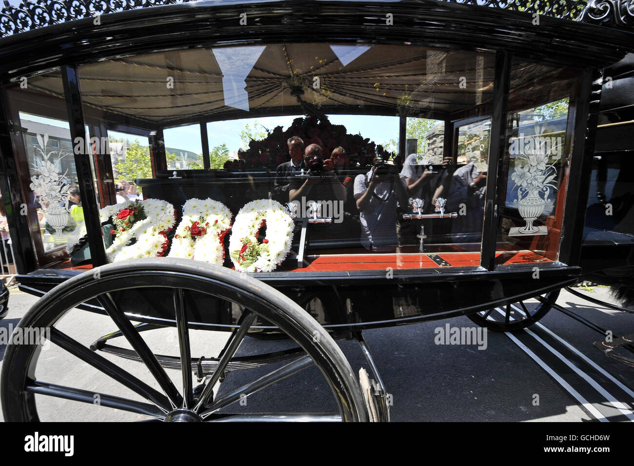 A flower tribute spells 'BRO' inside the horse led carriage carrying ...