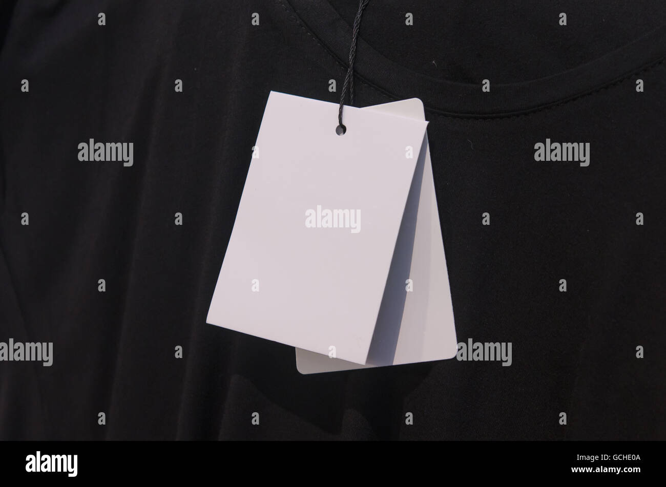 blank t-shirt and blank label tag Stock Photo - Alamy