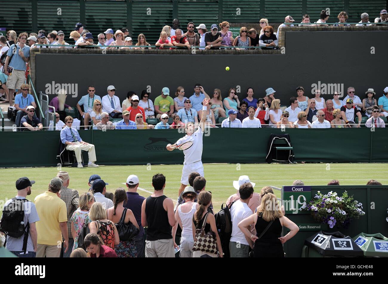 Spectators watch the action on the outside courts at the All England ...