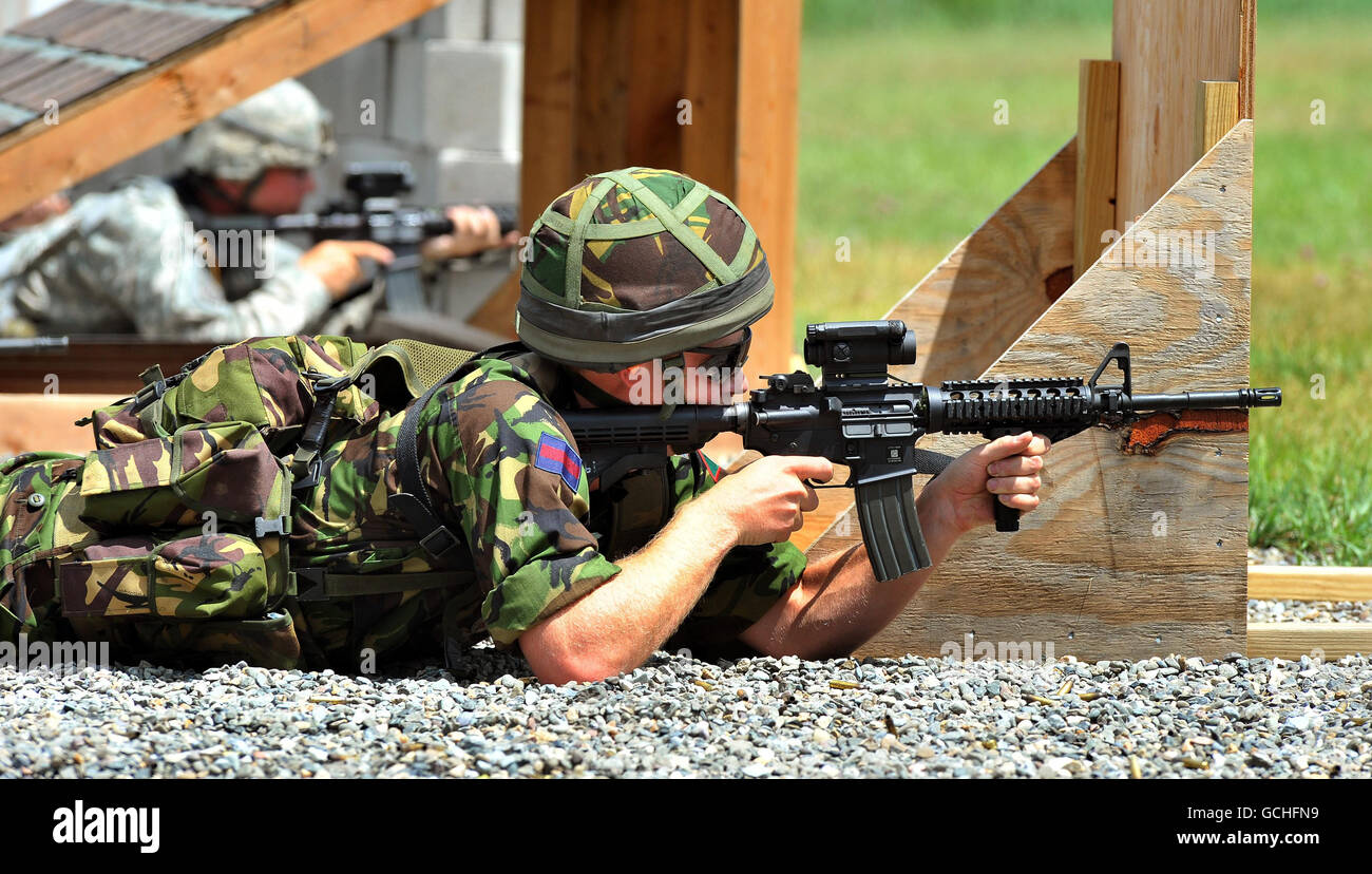 Prince Harry lays down during a live firing at the Fort Buckner ...