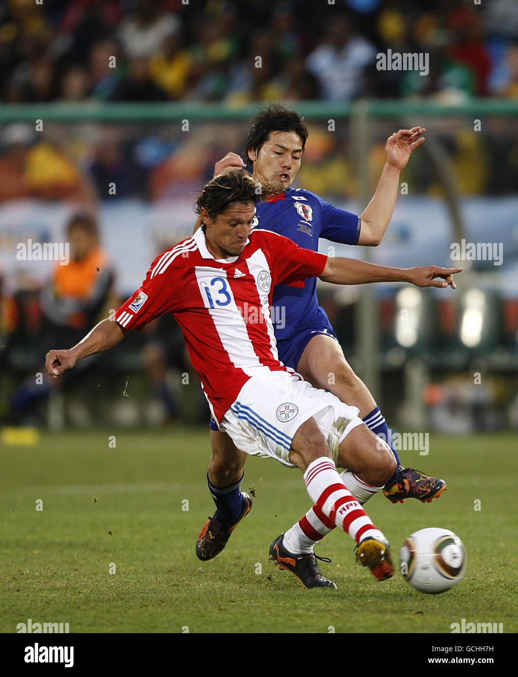 Japan's Daisuke Matsui (right) and Paraguay's Enrique Vera (left) battle for the ball Stock ...