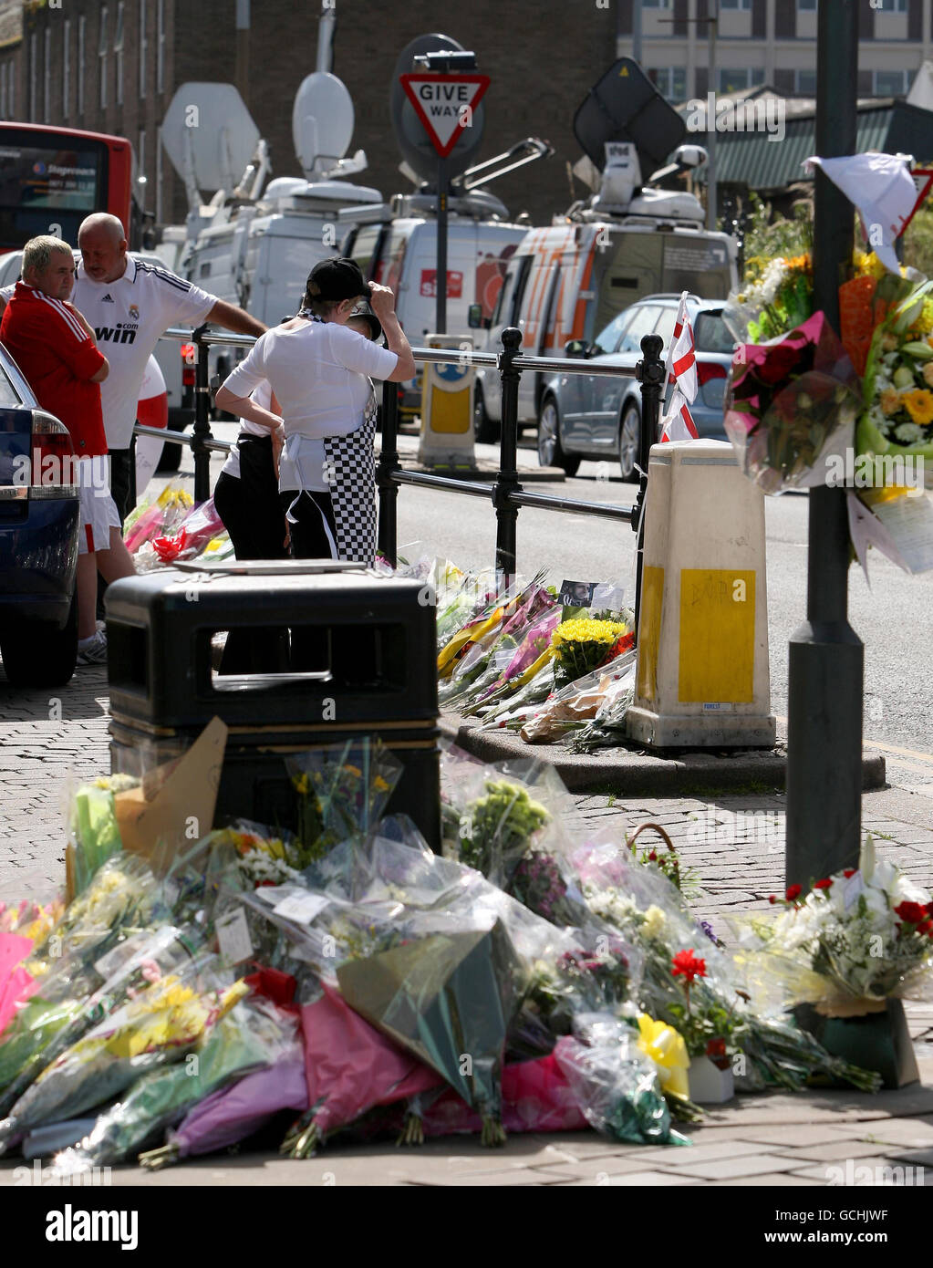 People look at flowers left at the Taxi rank in Whitehaven with the ...