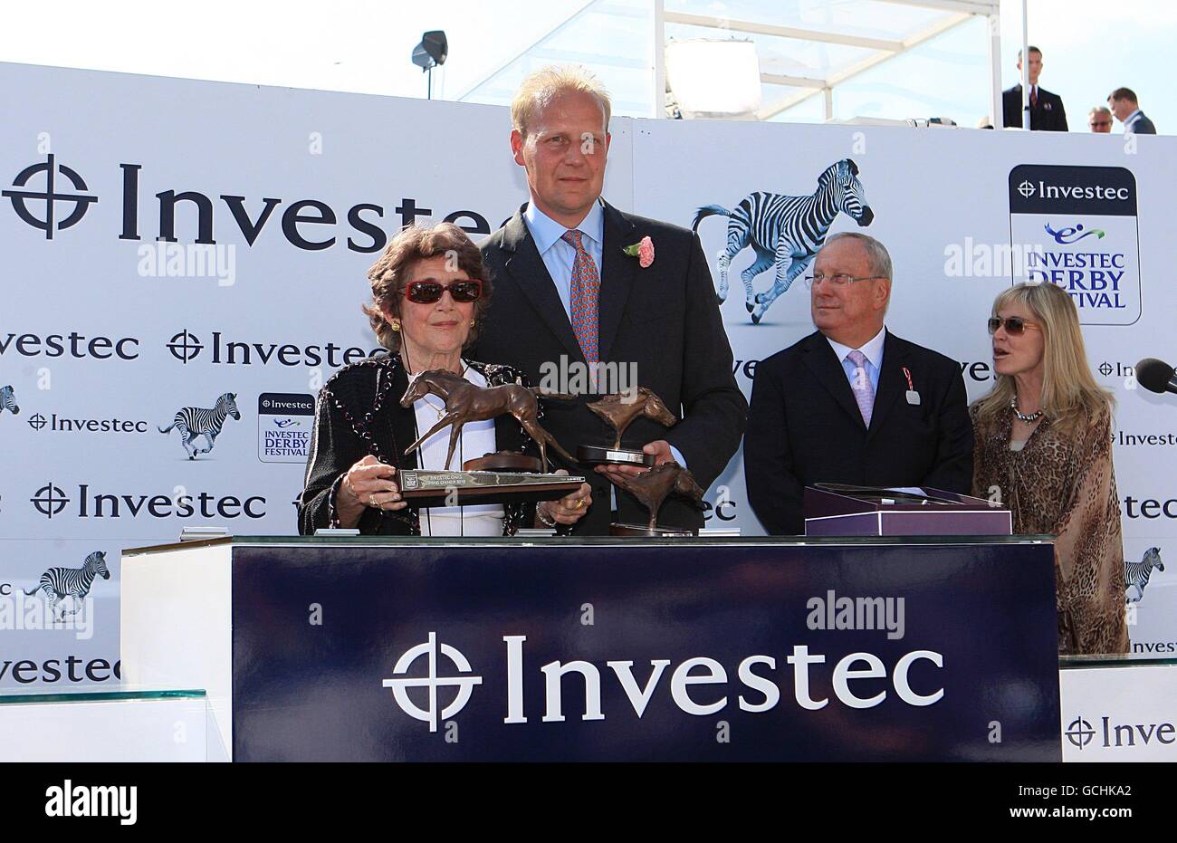 Trainer Ed Dunlop collects his trophy after Snow Fairy won the Investec ...