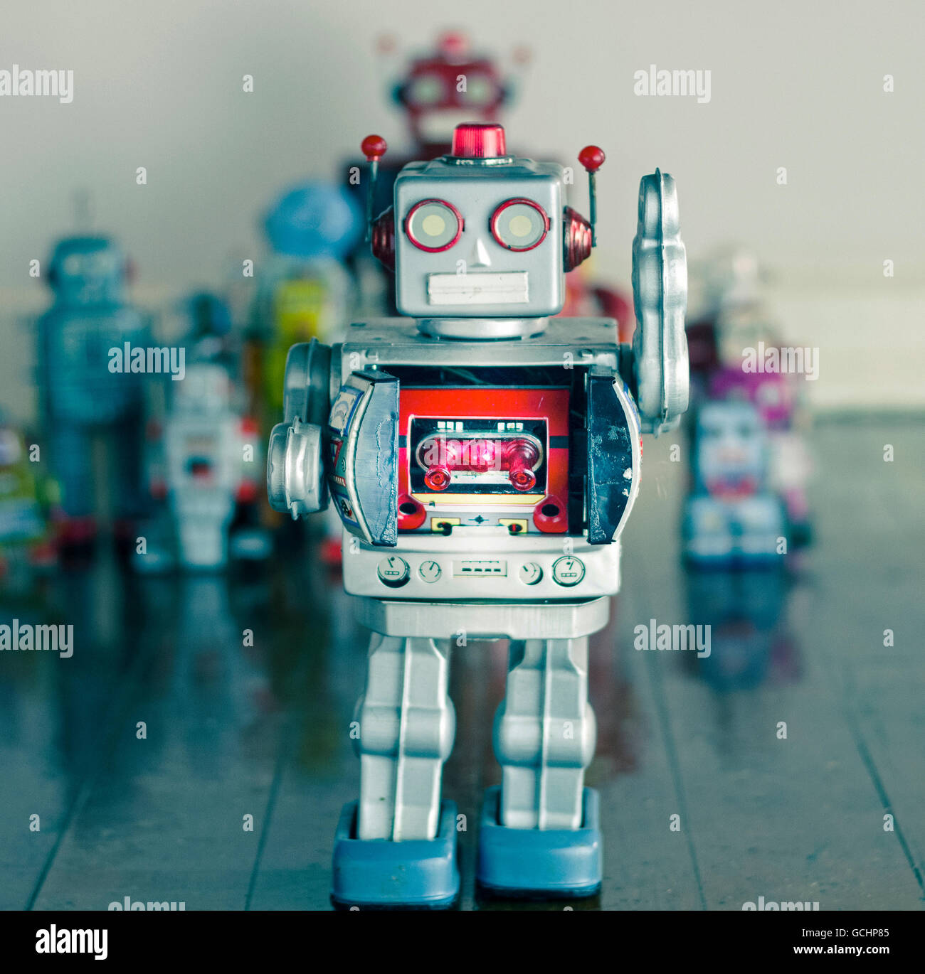 silver robot toy on wooden floor Stock Photo - Alamy