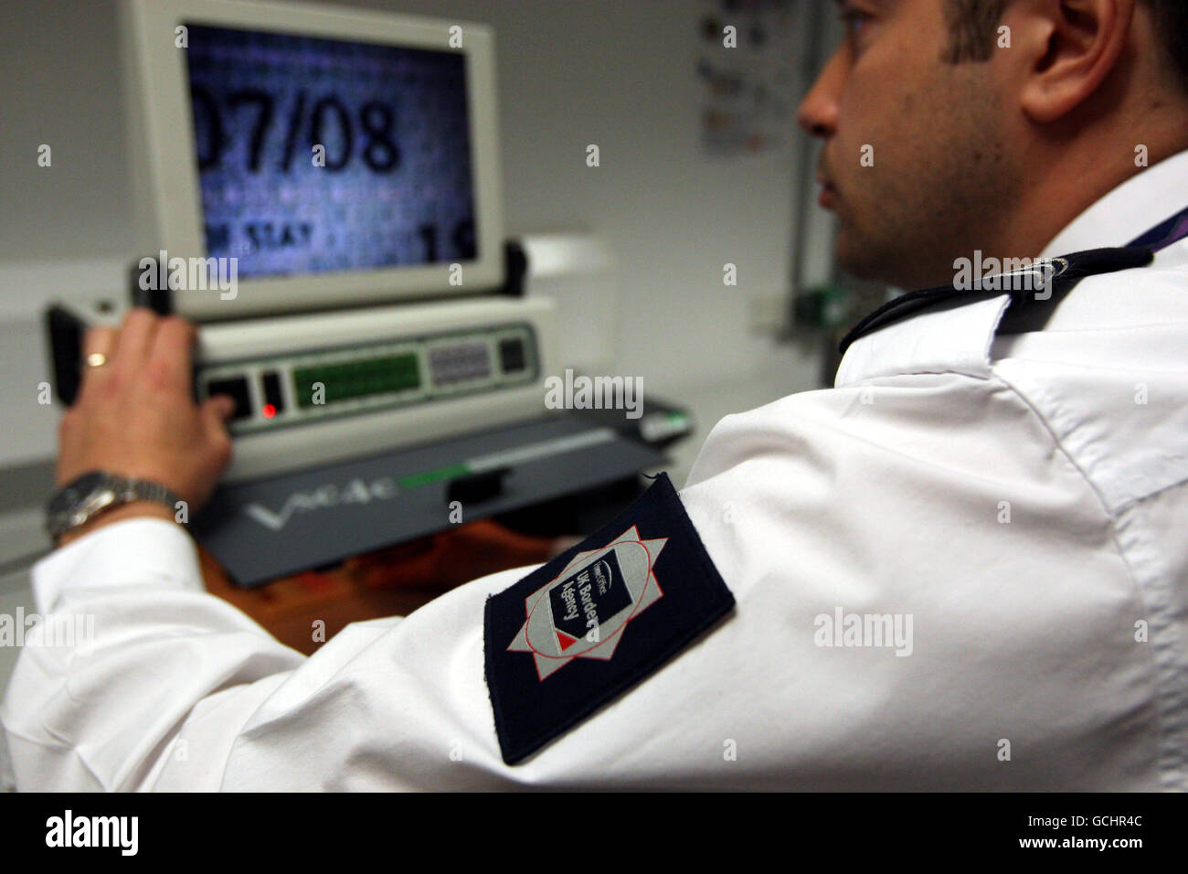 A UK Border Agency officer at Heathrow Airport in Middlesex as Home ...