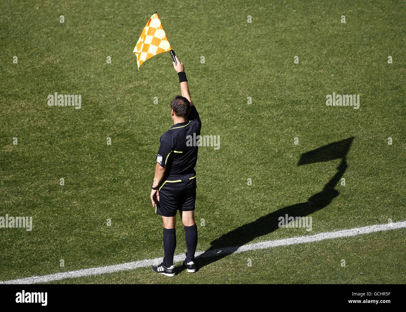 A view of the linesman raising his flag during the match Stock Photo ...