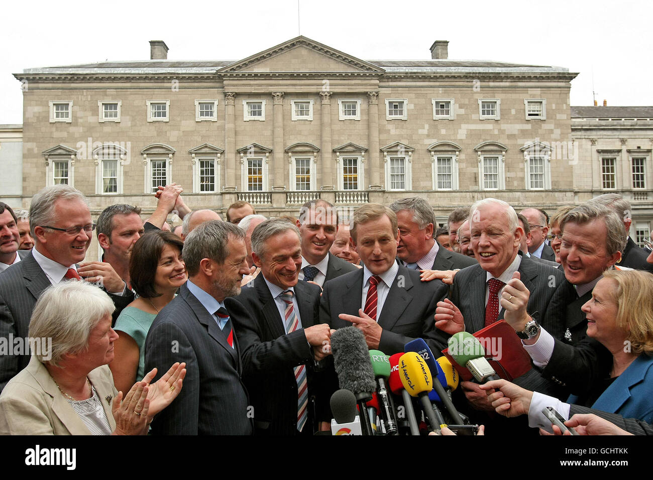 Fine Gael Leader Enda Kenny (centre, red striped tie) smiles as he ...