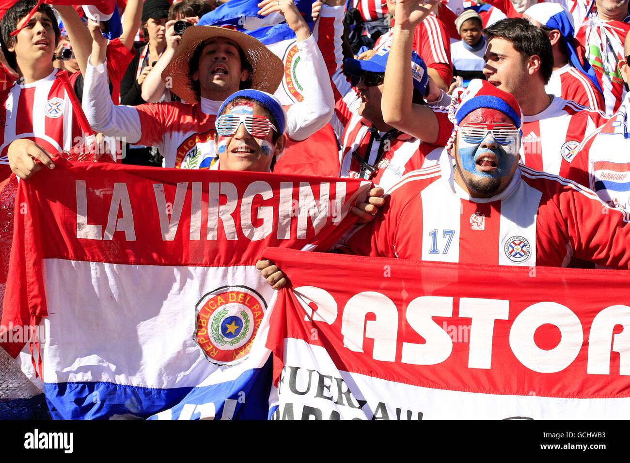 Paraguay fans cheer on their side in the stands hi-res stock ...